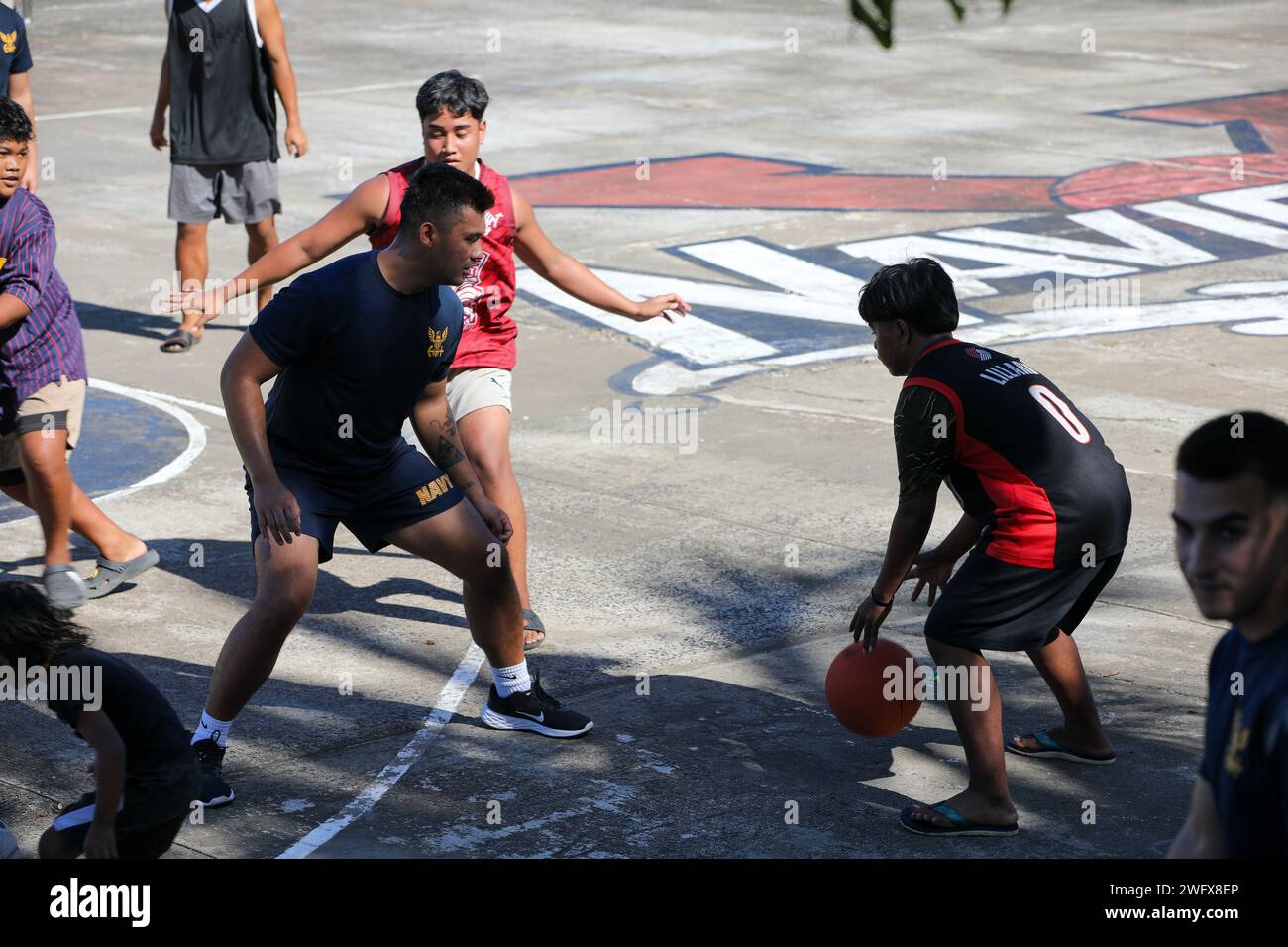 U.S. Navy Sailors play basketball with students during a host nation ...
