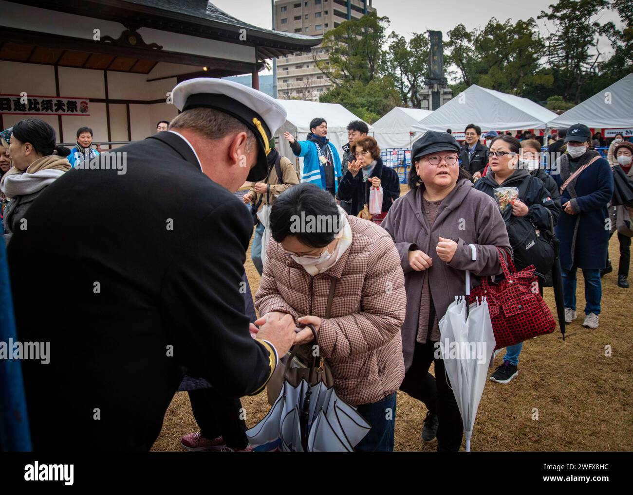 Capt. Michael Fontaine, Commander, Fleet Activities Sasebo, hands out ...