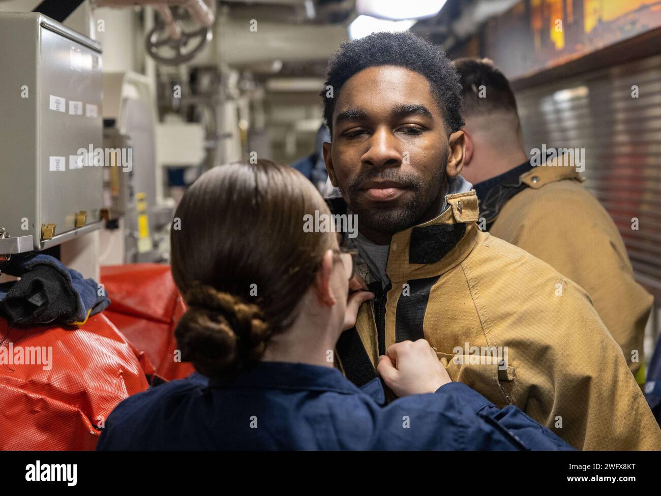 YOKOSUKA, Japan (Jan. 30, 2024) Fireman Nashawn Hicks dresses out to ...