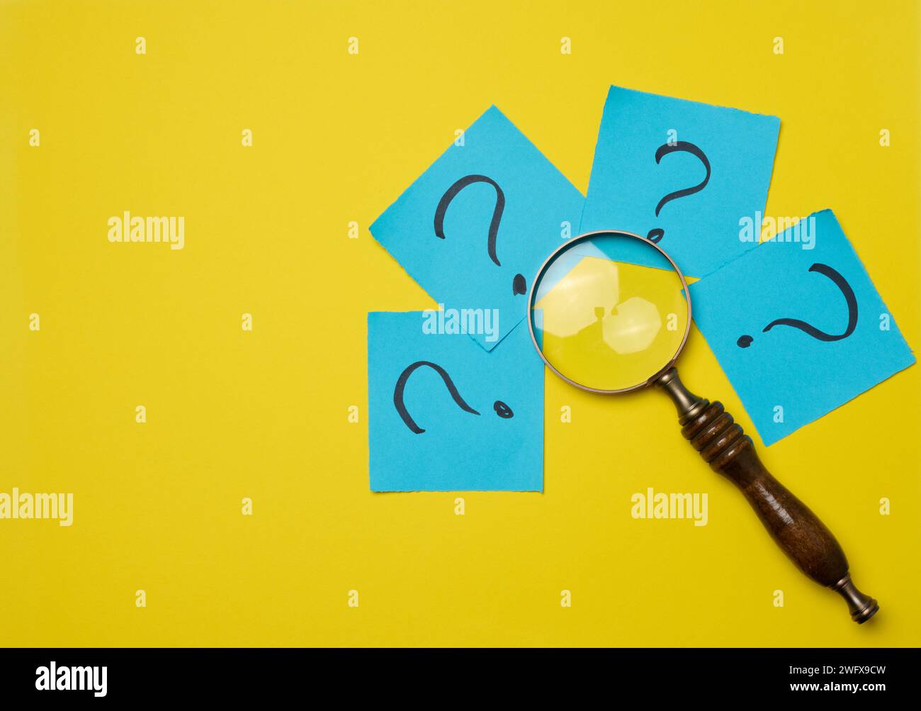 Drawn question marks on stickers and a magnifying glass, yellow ...