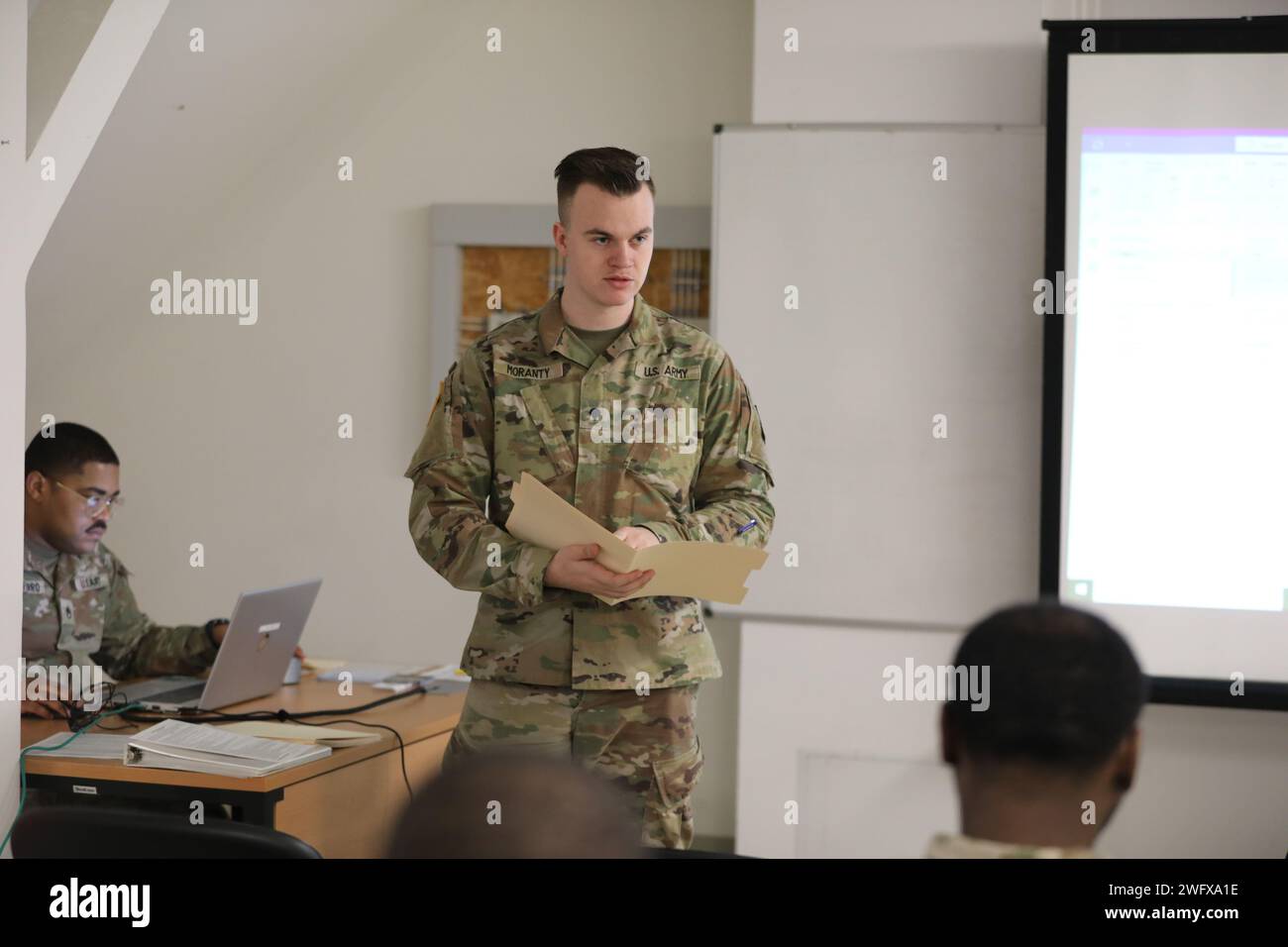 U.S. Army Spc. Landon Moranty, gives a security brief to the newly ...