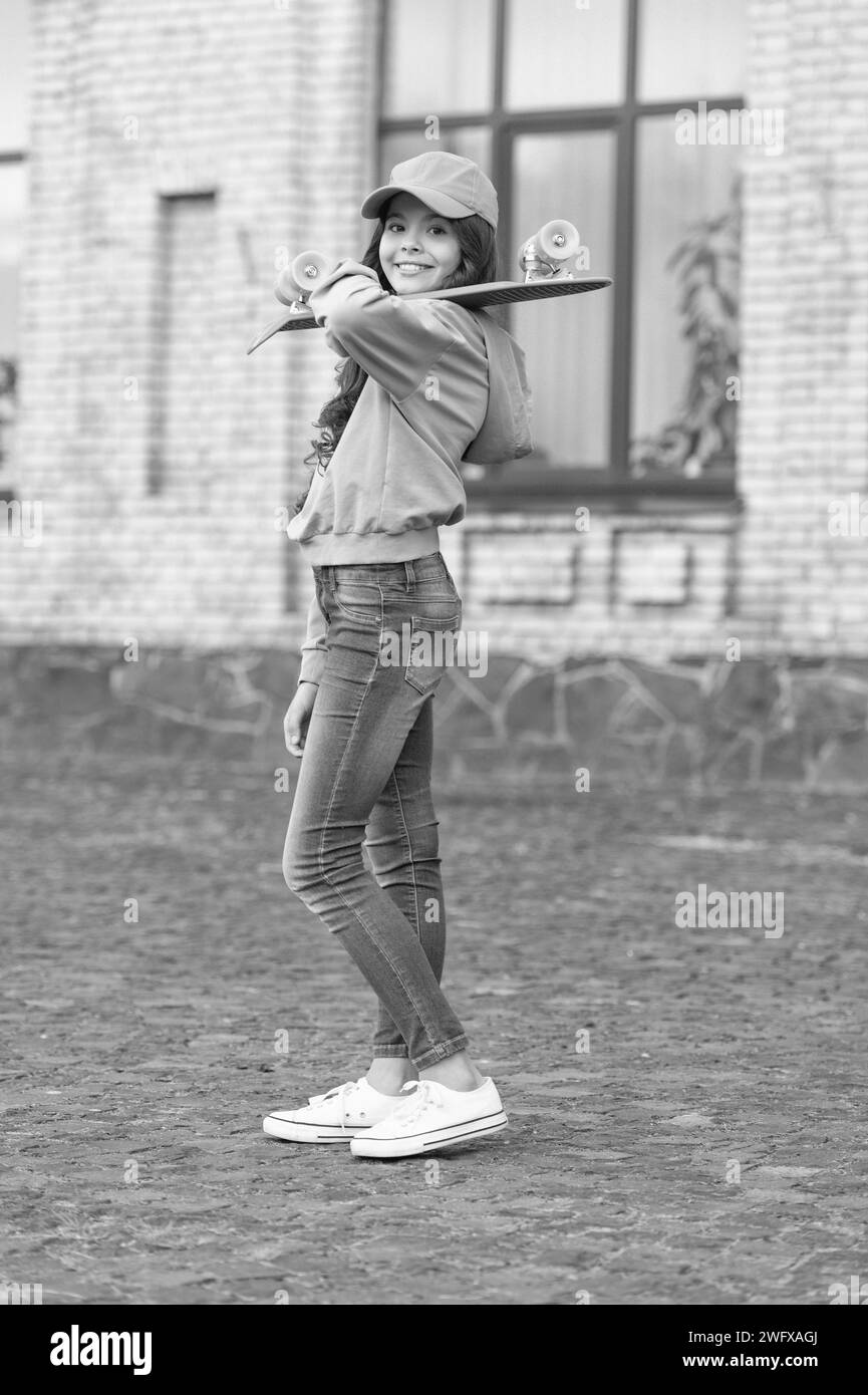 happy teen kid skater with skateboard outdoor. girl with penny board ...