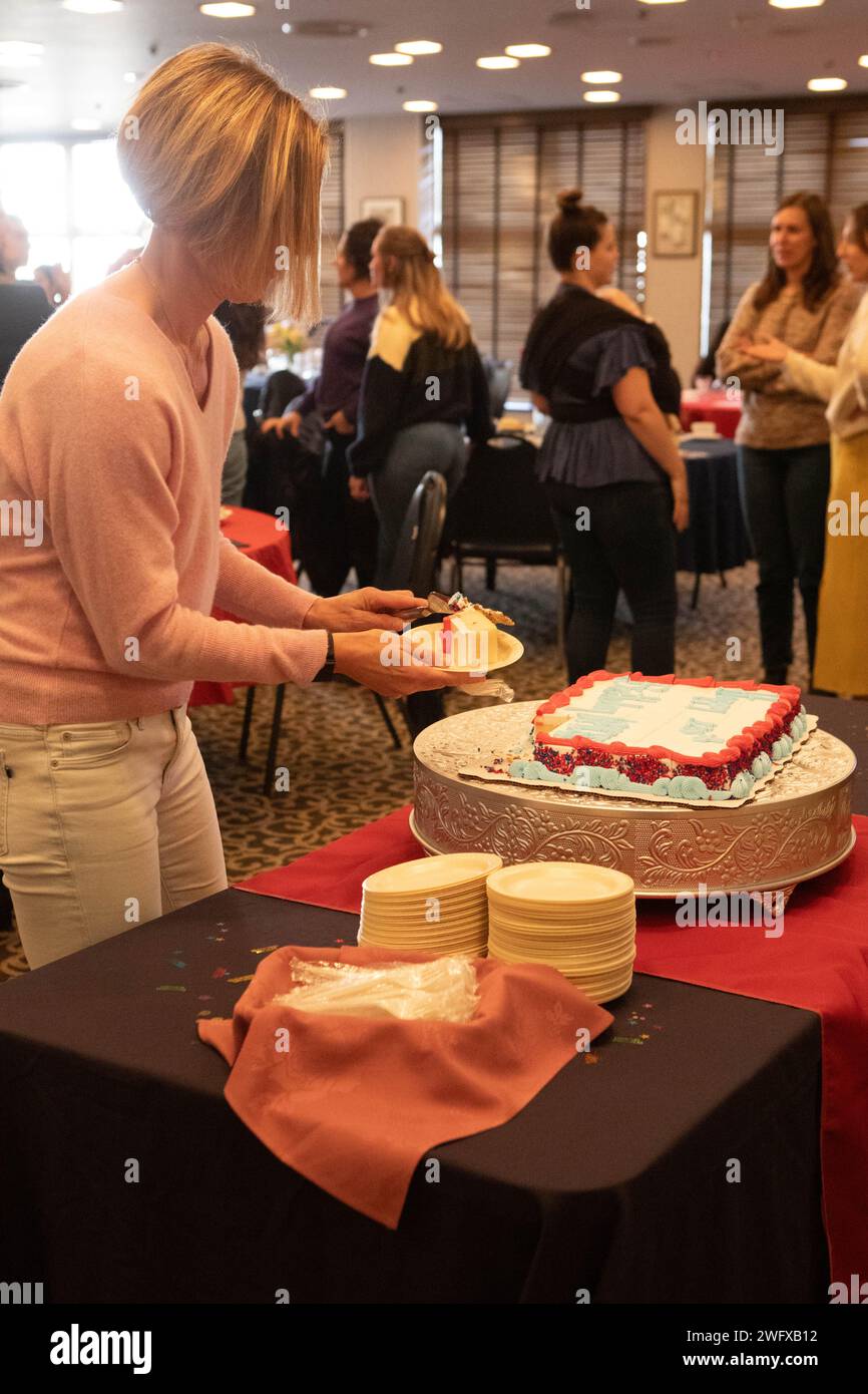 Sara Shoop, the Iwakuni Food Pantry chairman, cuts a piece of cake ...
