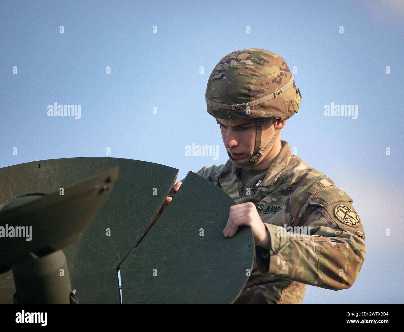 Sgt. Shawn Heisler assembles a satellite in the area of operations for ...