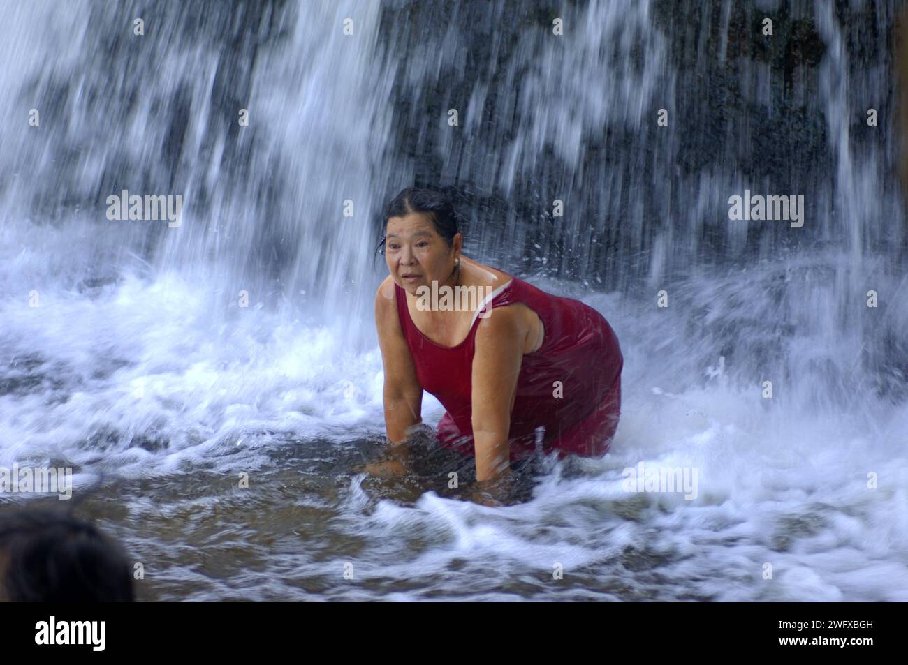 Cambodian woman bathing at Phnom Kulen Waterfall, Phnom Kulen National ...