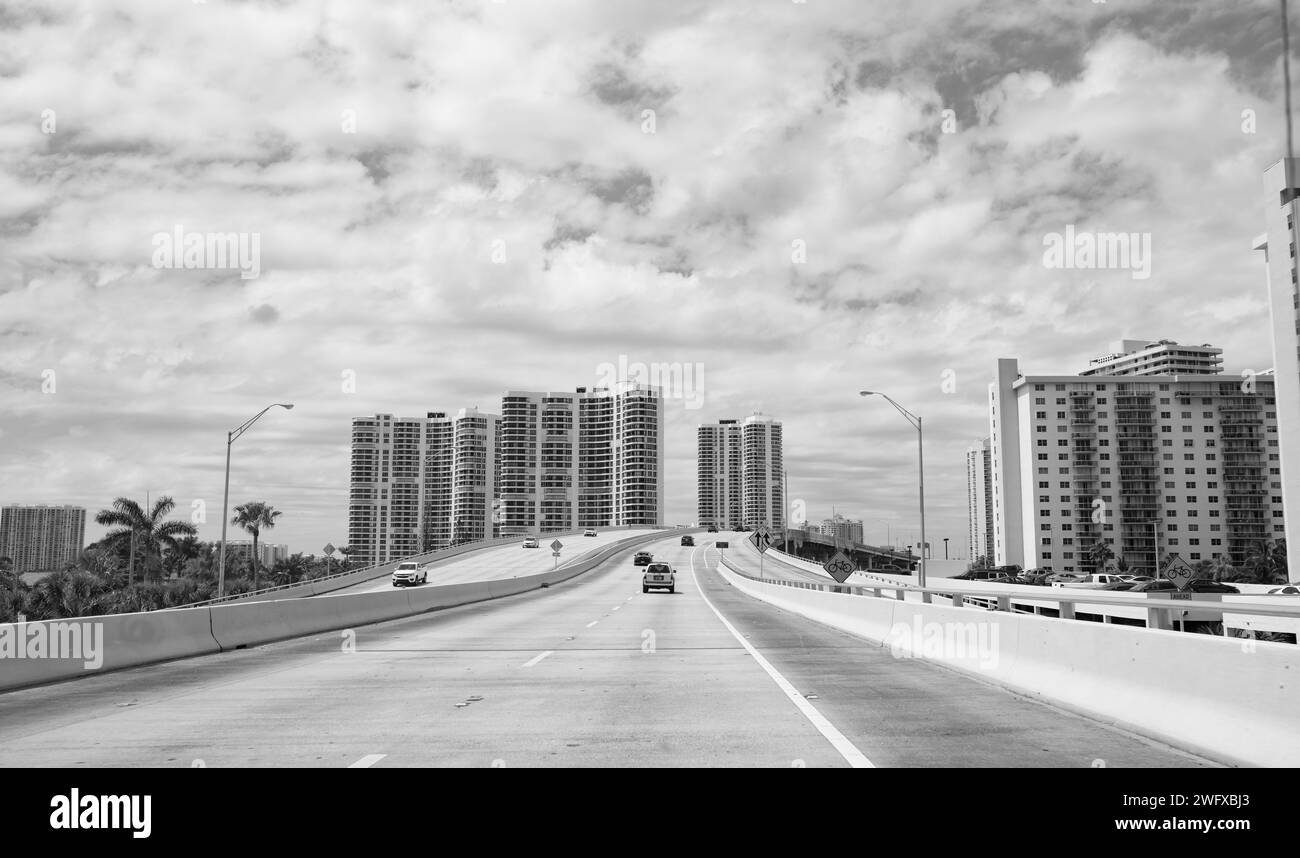 Miami, USA - March 21, 2021: skyscraper buildings with cars on highway ...