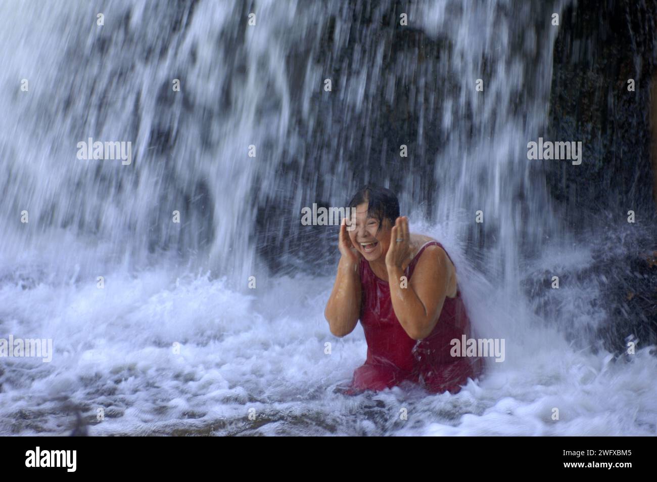 Cambodian woman bathing at Phnom Kulen Waterfall, Phnom Kulen National ...