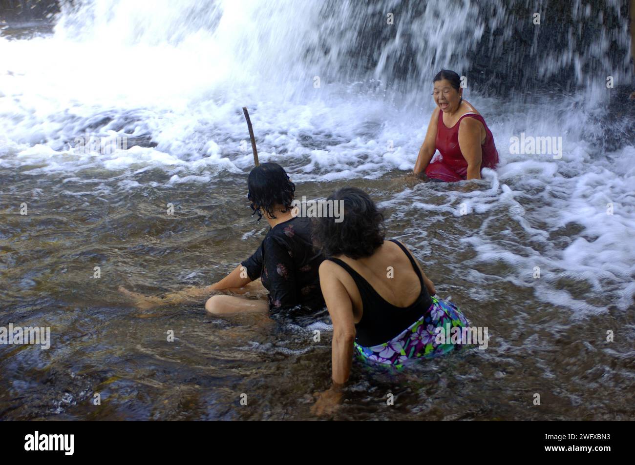 Three local Cambodian women bathing in the Phnom Kulen Waterfall, Phnom ...