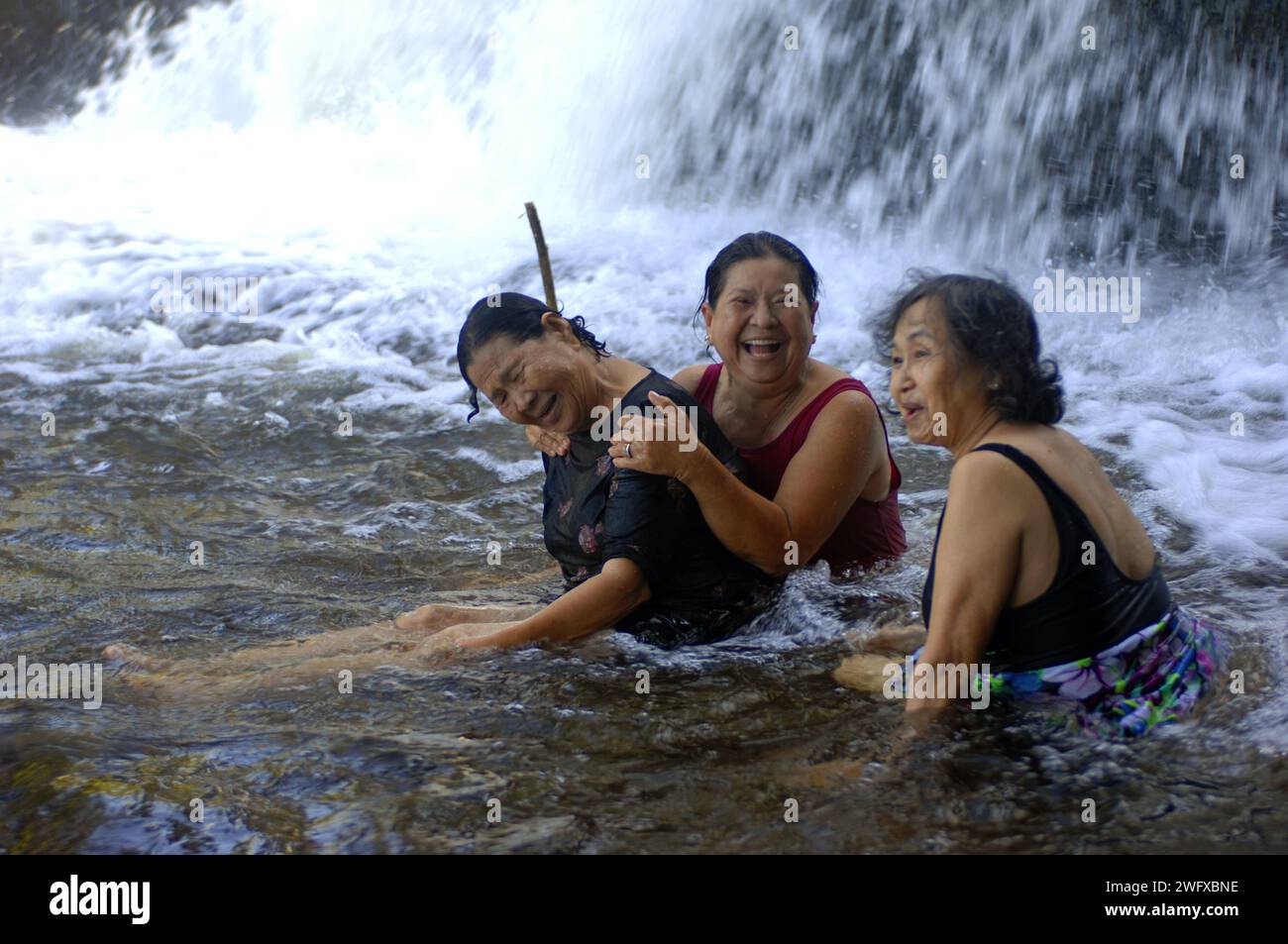 Three local Cambodian women bathing in the Phnom Kulen Waterfall, Phnom ...