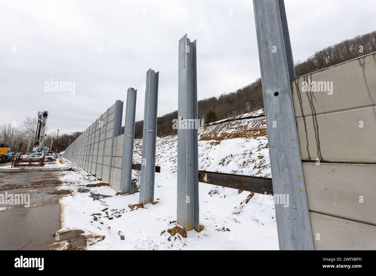 A retaining wall stands nearly complete to support a site where the U.S ...