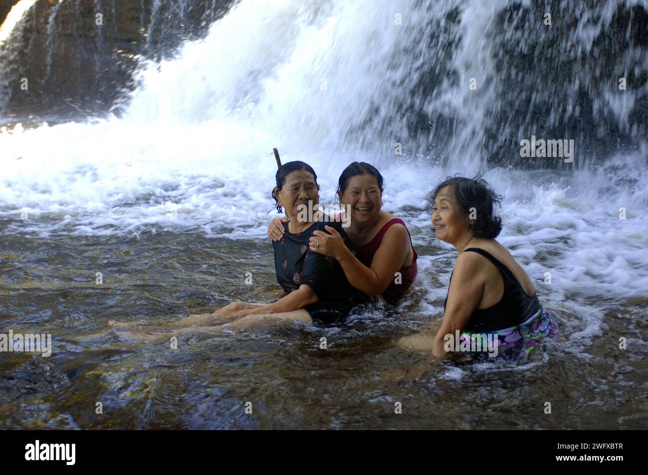 Three local Cambodian women bathing in the Phnom Kulen Waterfall, Phnom ...