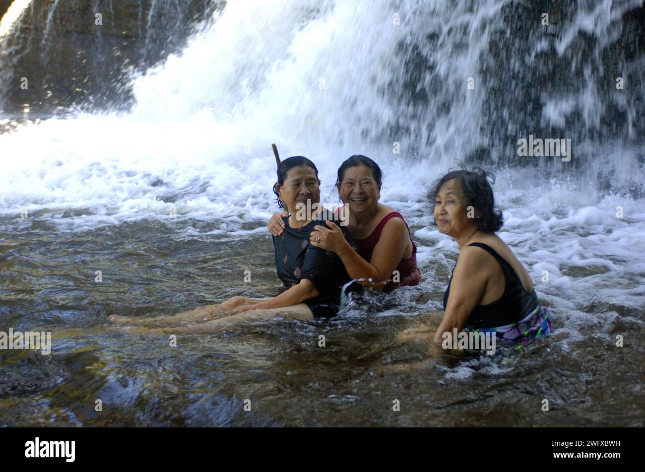Three local Cambodian women bathing in the Phnom Kulen Waterfall, Phnom ...