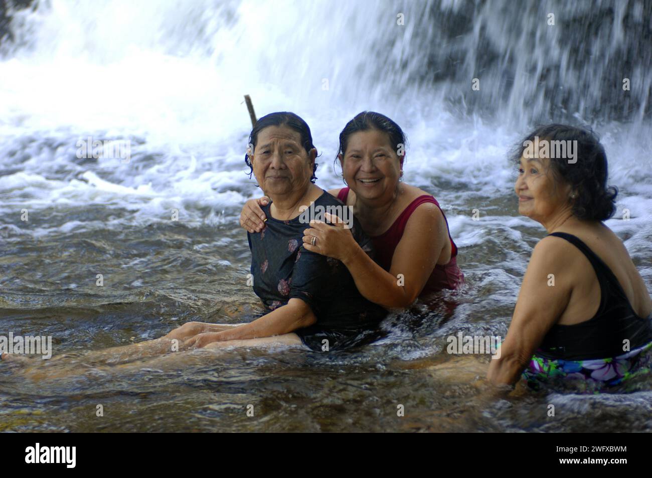 Three local Cambodian women bathing in the Phnom Kulen Waterfall, Phnom ...