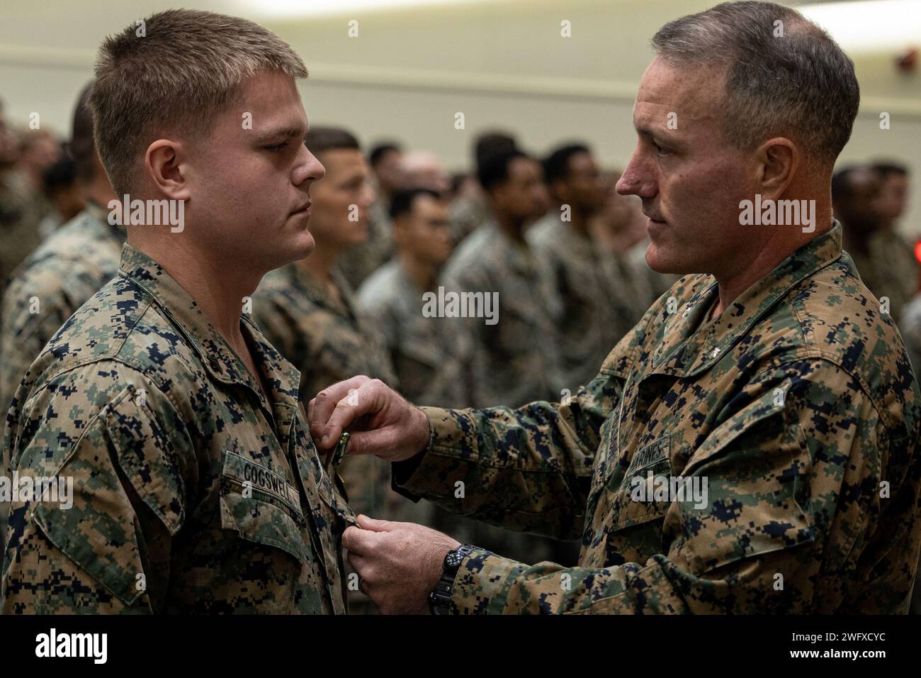 U.S. Marines Corps Lt. Col. Andrew Nicholson, right, presents a Navy ...