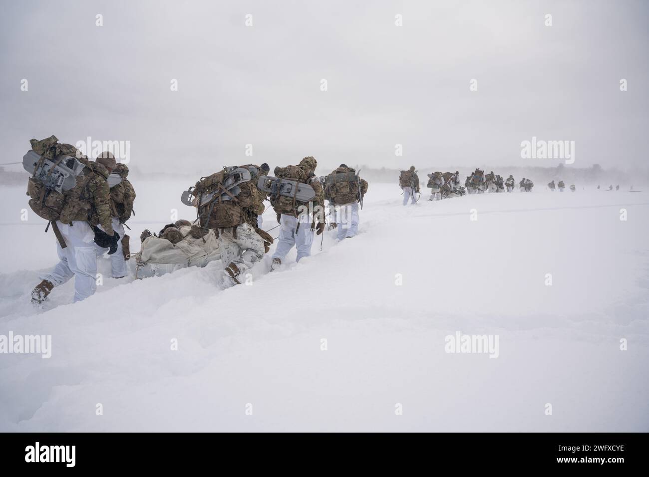 10th Mountain Division Soldiers trek through the snow after they were ...