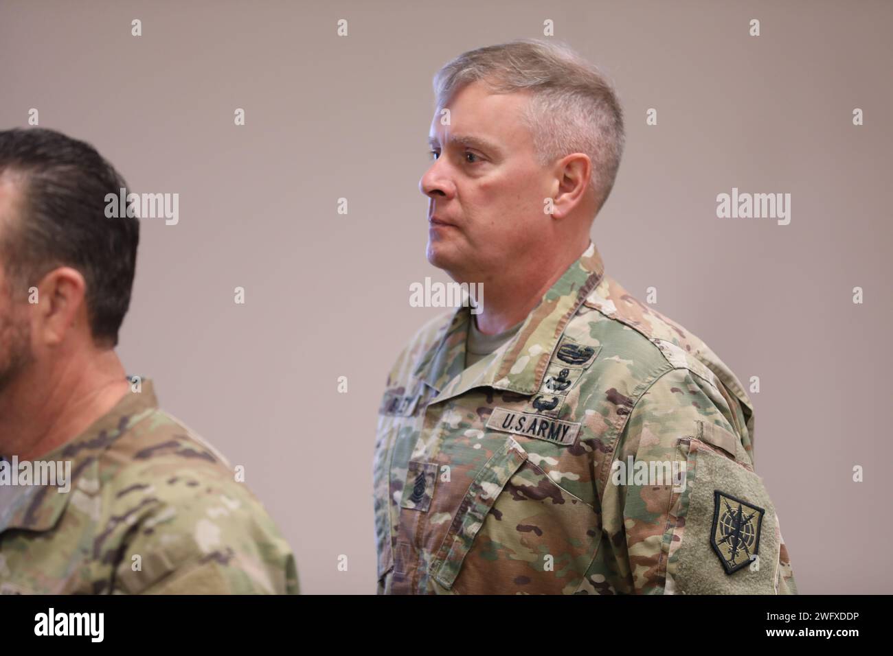 Command Sgt. Maj. Edward Bailey stands at attention during a change of ...