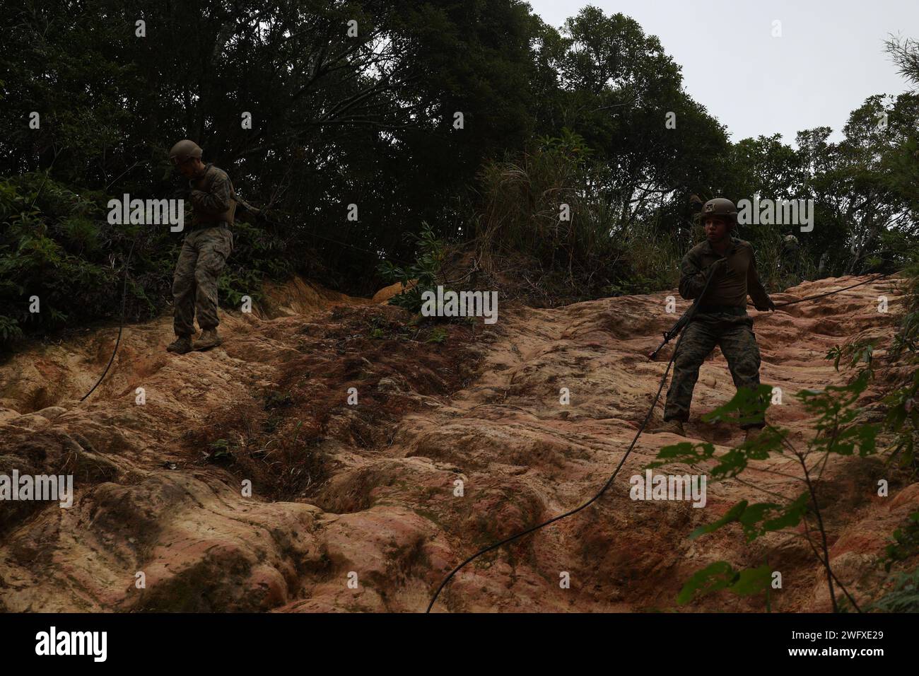 U.S. Marines with III Marine Expeditionary Force conduct a hasty rappel ...