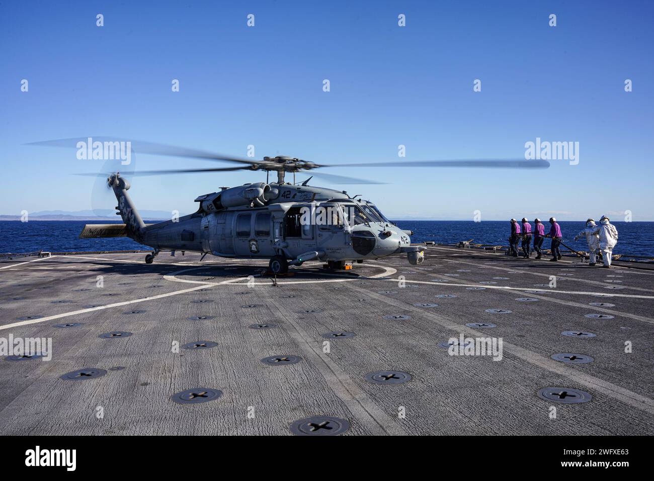 Sailors prepare to refuel an SH-60S Seahawk, attached to Helicopter Sea ...