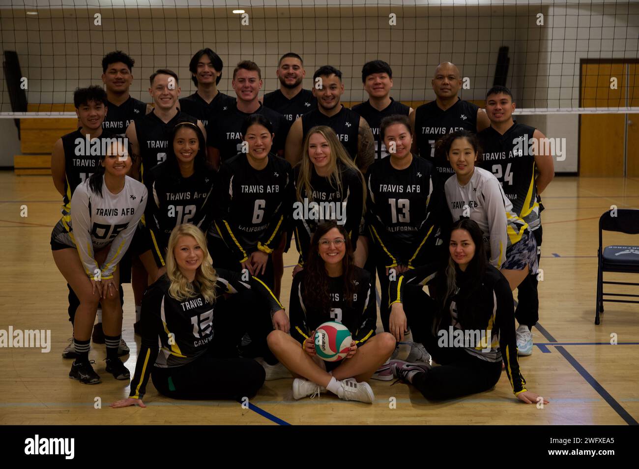 U.S. Airmen on the Travis Air Force Base volleyball team pose for a ...