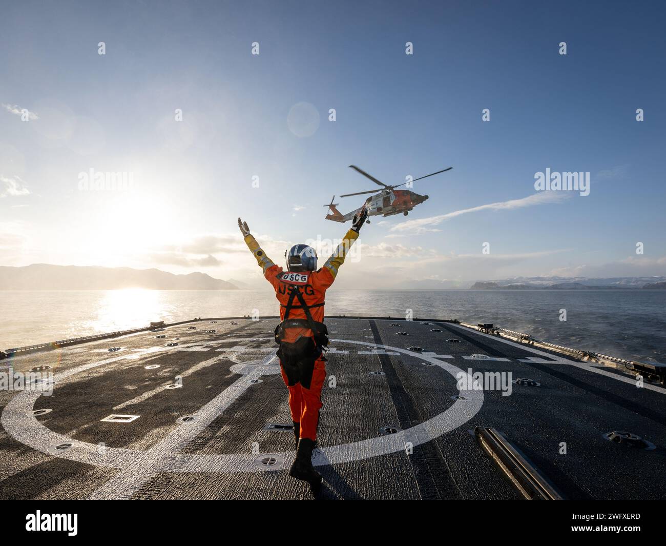 A crew member from Coast Guard Cutter Alex Haley conducting helicopter ...