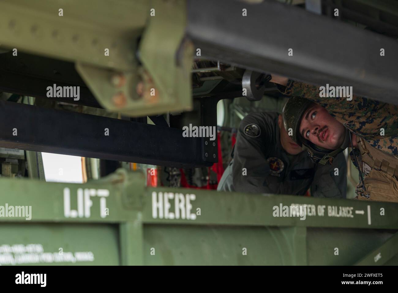 U.S. Marine Corps Cpl. Cole Baker loads rocket munition pods for a High ...