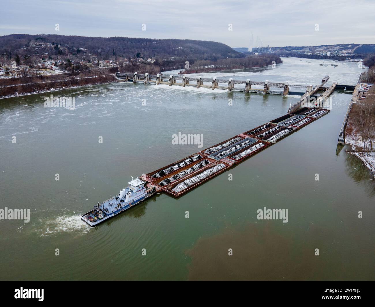 A towboat pushes 15 barges, most filled with coal, on the Ohio River ...