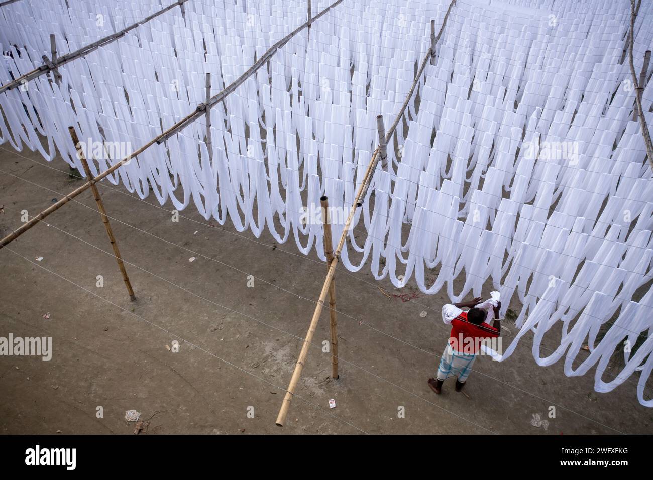 Aerial view of people working in a public laundry hanging for drying ...