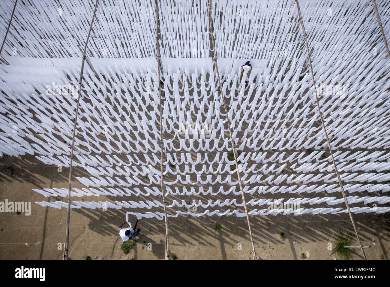 Aerial view of people working in a public laundry hanging for drying ...
