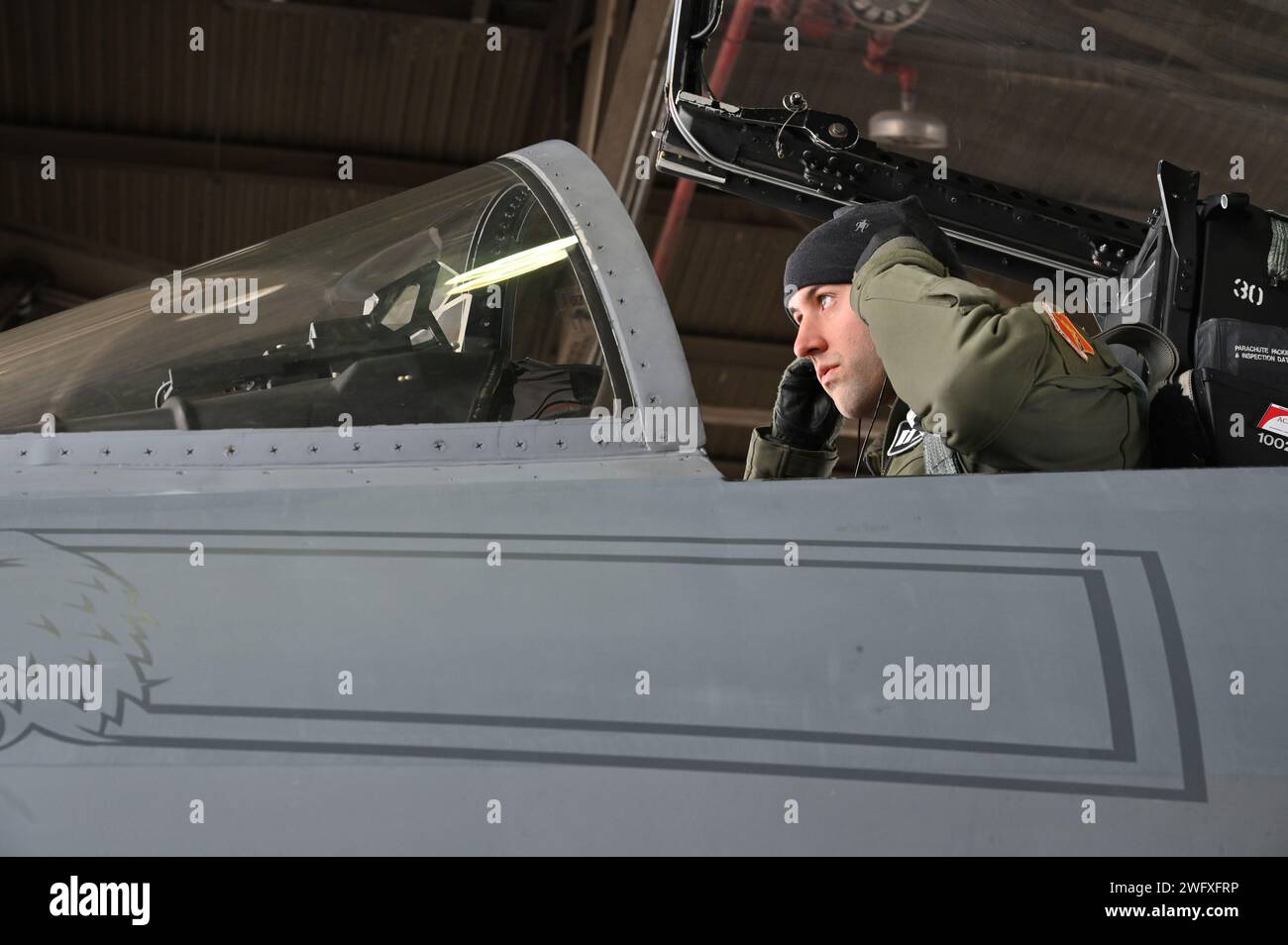 U.S. Air Force Capt. Andrew Marshall, an F-15C pilot with the 550th Fighter Squadron, settles ...