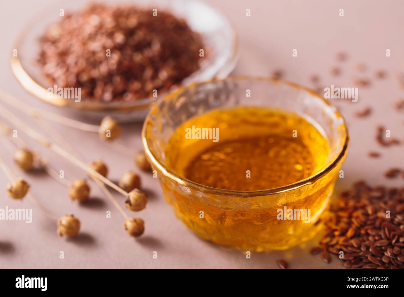 Brown linen seeds, flaxseed vegetable oil on beige background Stock ...