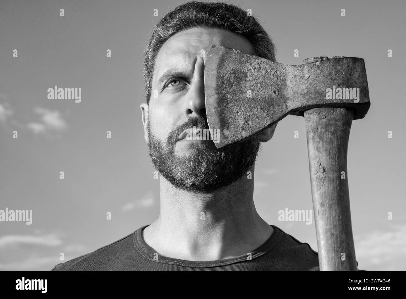 confident man cover face with axe. caucasian man hold ax. brutal man on ...
