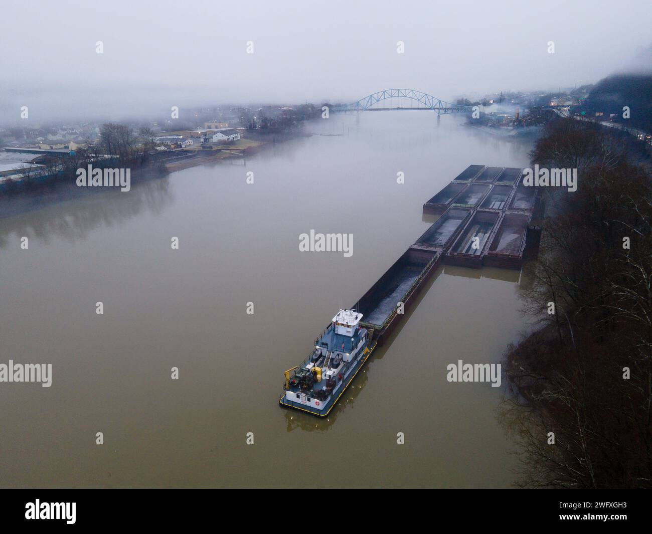 A towboat stages barges during foggy conditions on the Monongahela ...