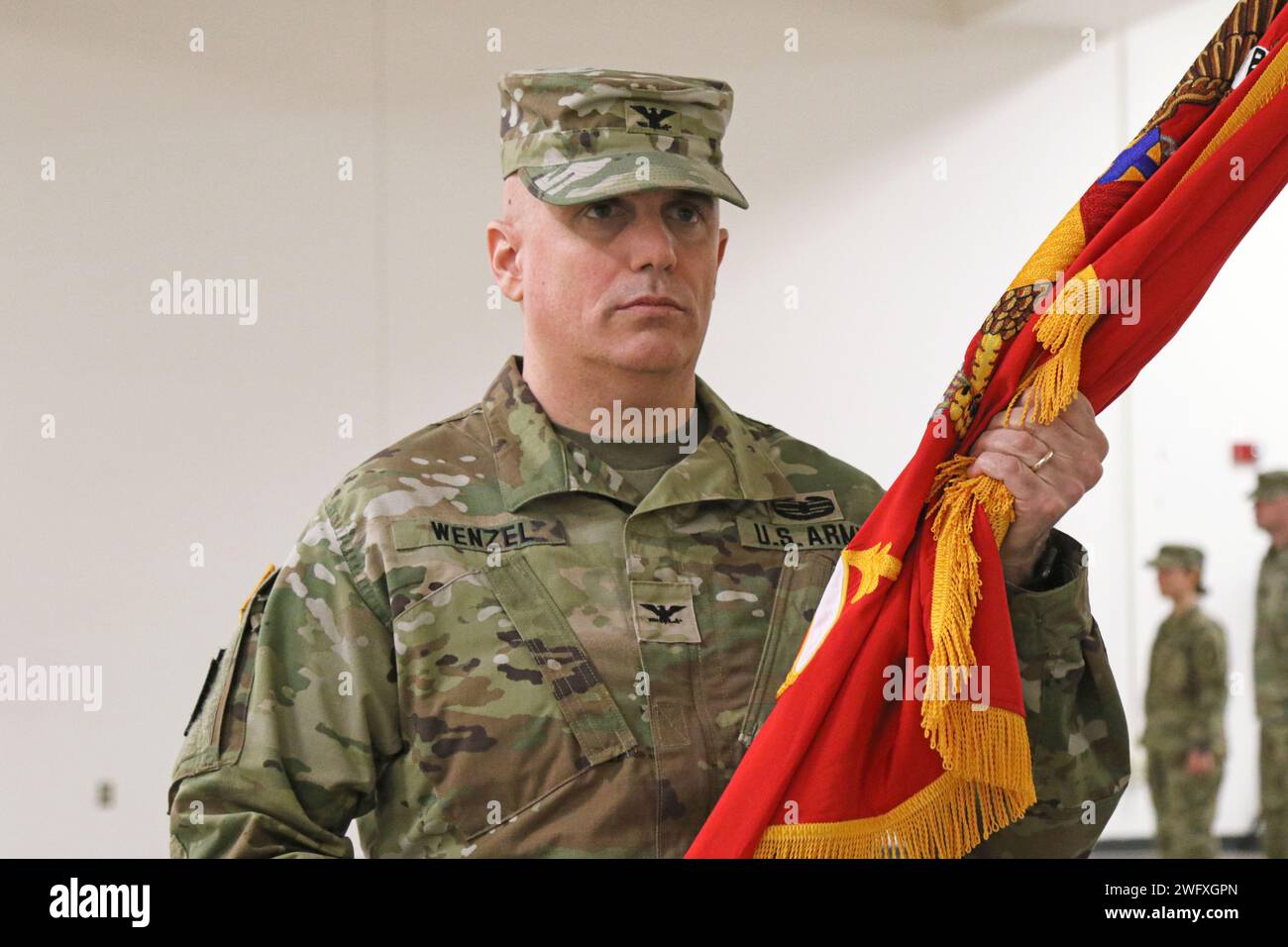 Col. John M. Wenzel, new commander of the 166th Regiment, stands with ...