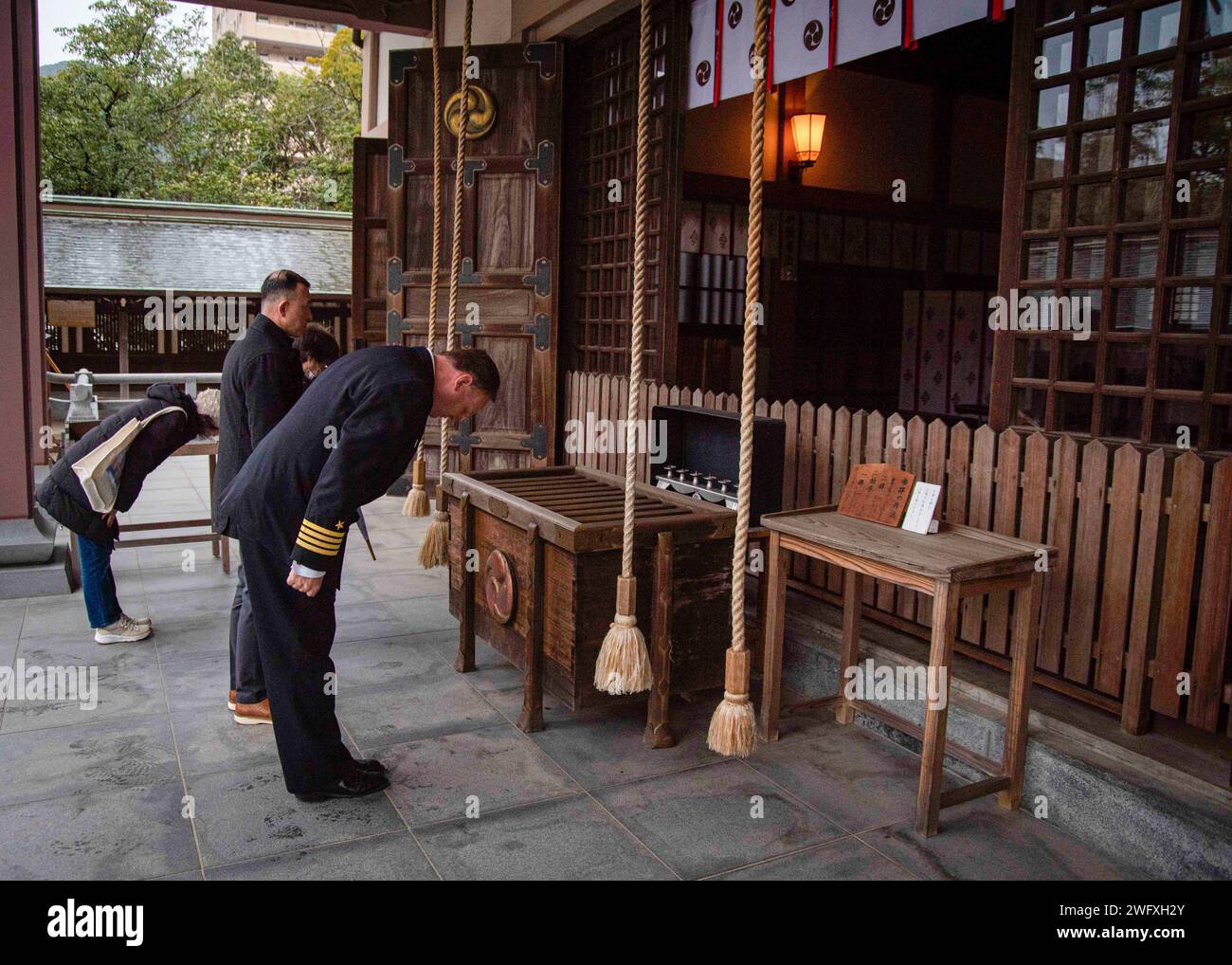 Capt. Michael Fontaine, Commander, Fleet Activities Sasebo, bows at a shrine during a Toka Ebisu ...