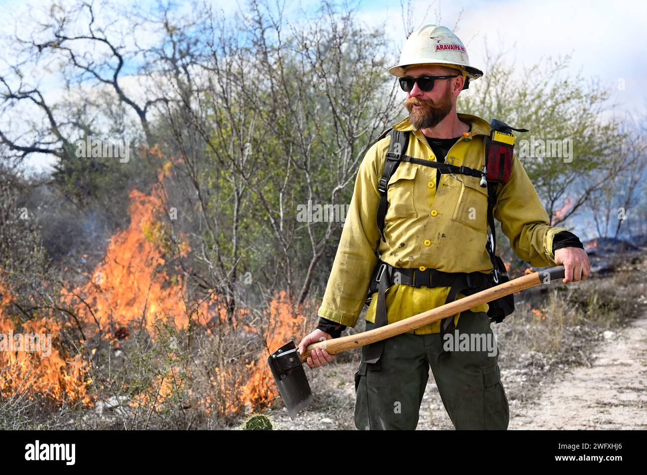 A firefighter, with the U.S. Air Force Wildland Fire Branch, observes ...