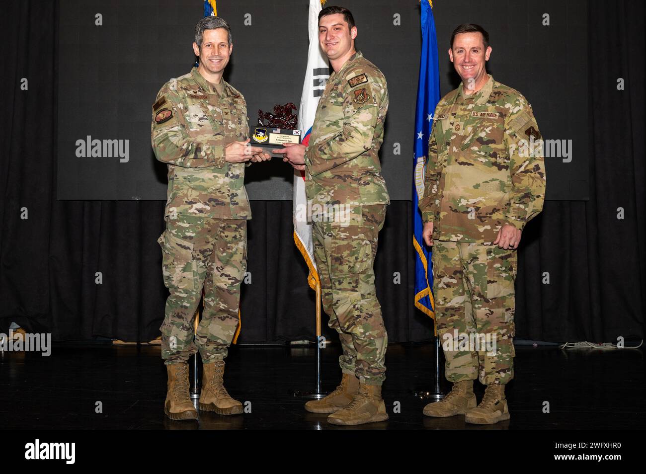 The 51st Fighter Wing command team presents the Airman of the quarter ...