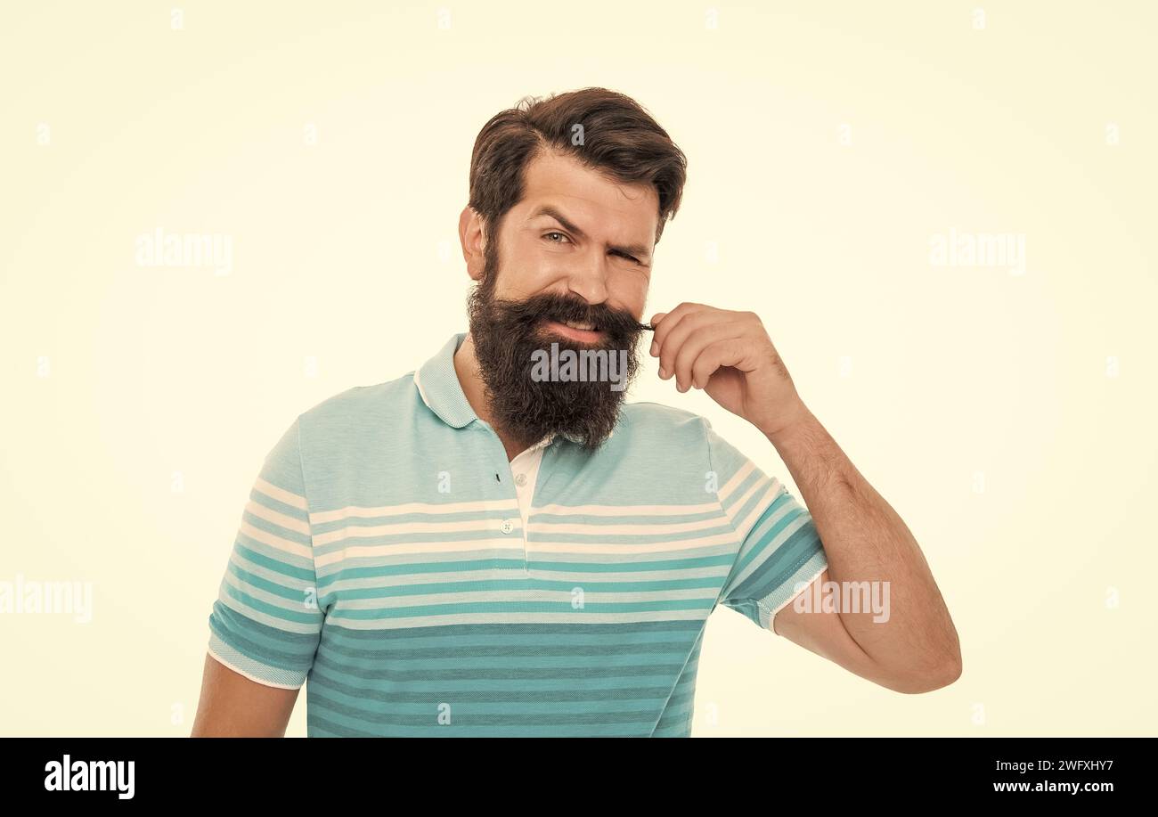 Bearded man twisting moustache. Unshaven man with long beard and ...