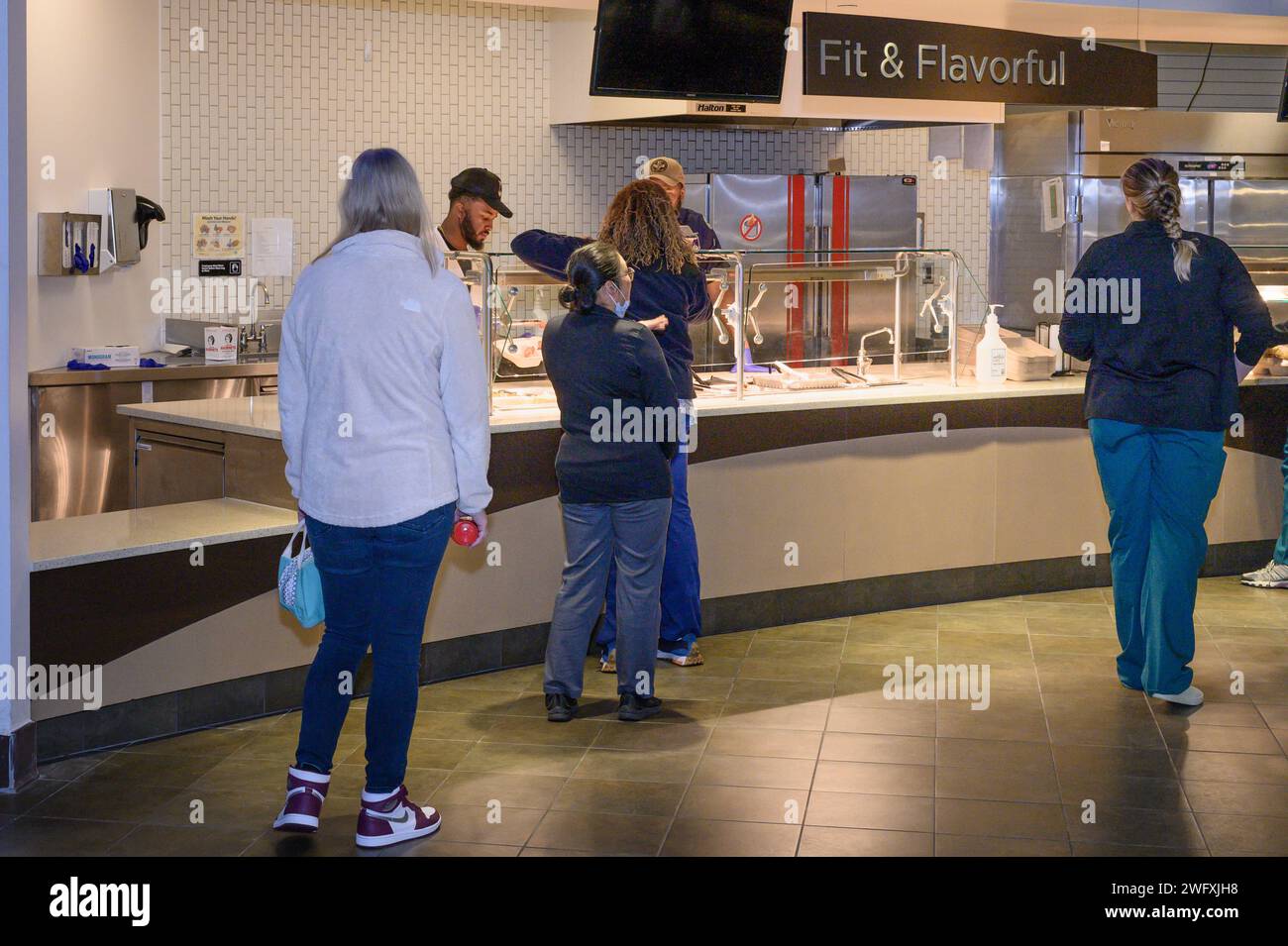 Patrons stand in line at Walter Reed's Café 8901 following hot food ...