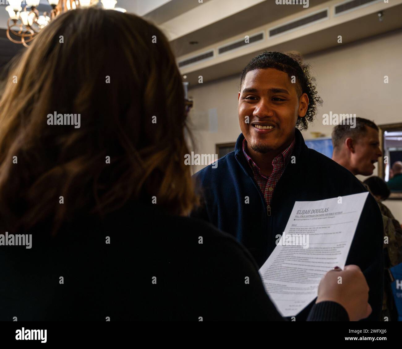 U.S. Air Force veteran, Elijah Douglas, speaks with an Amazon recruiter ...