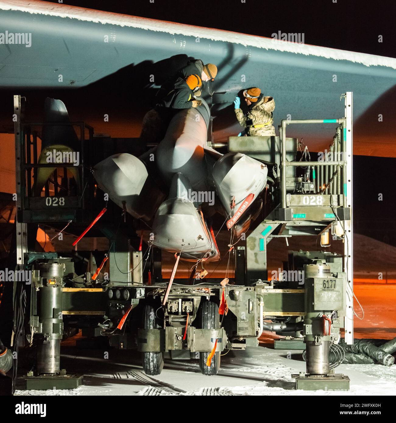 Airmen with the 5th Maintenance Group load AGM-86 air-launched cruise ...