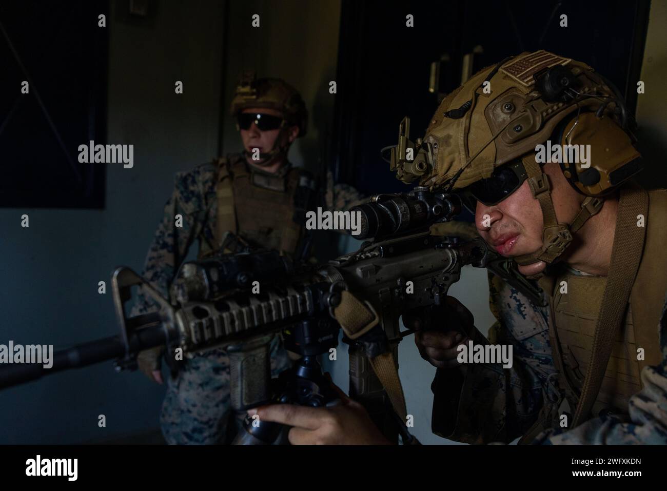 U.S. Marine Corps Cpl. Abel Campos, a scout sniper with Battalion Landing Team 1/1, fires on a ...