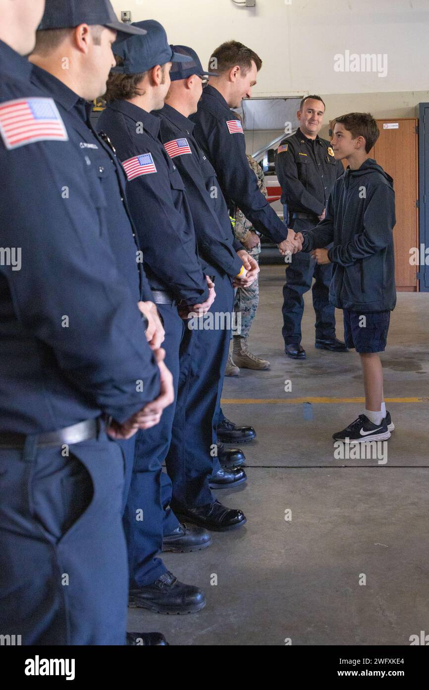 Declan Henson, a military dependent, presents the Marine Corps Installation Command Lifesaver ...