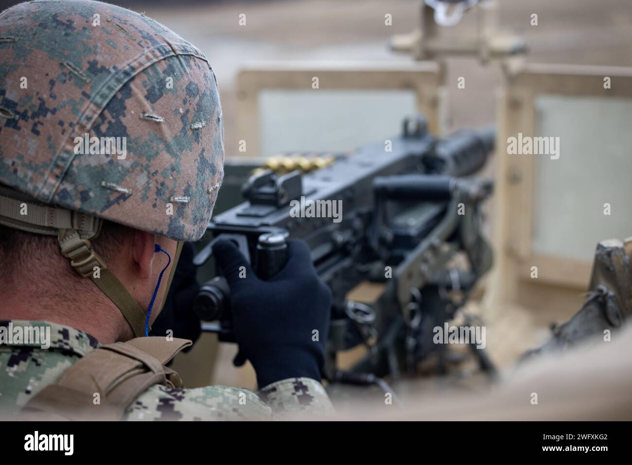 U.S. Navy Capt. Nakia Cooper, commodore, Amphibious Squadron 4, fires ...