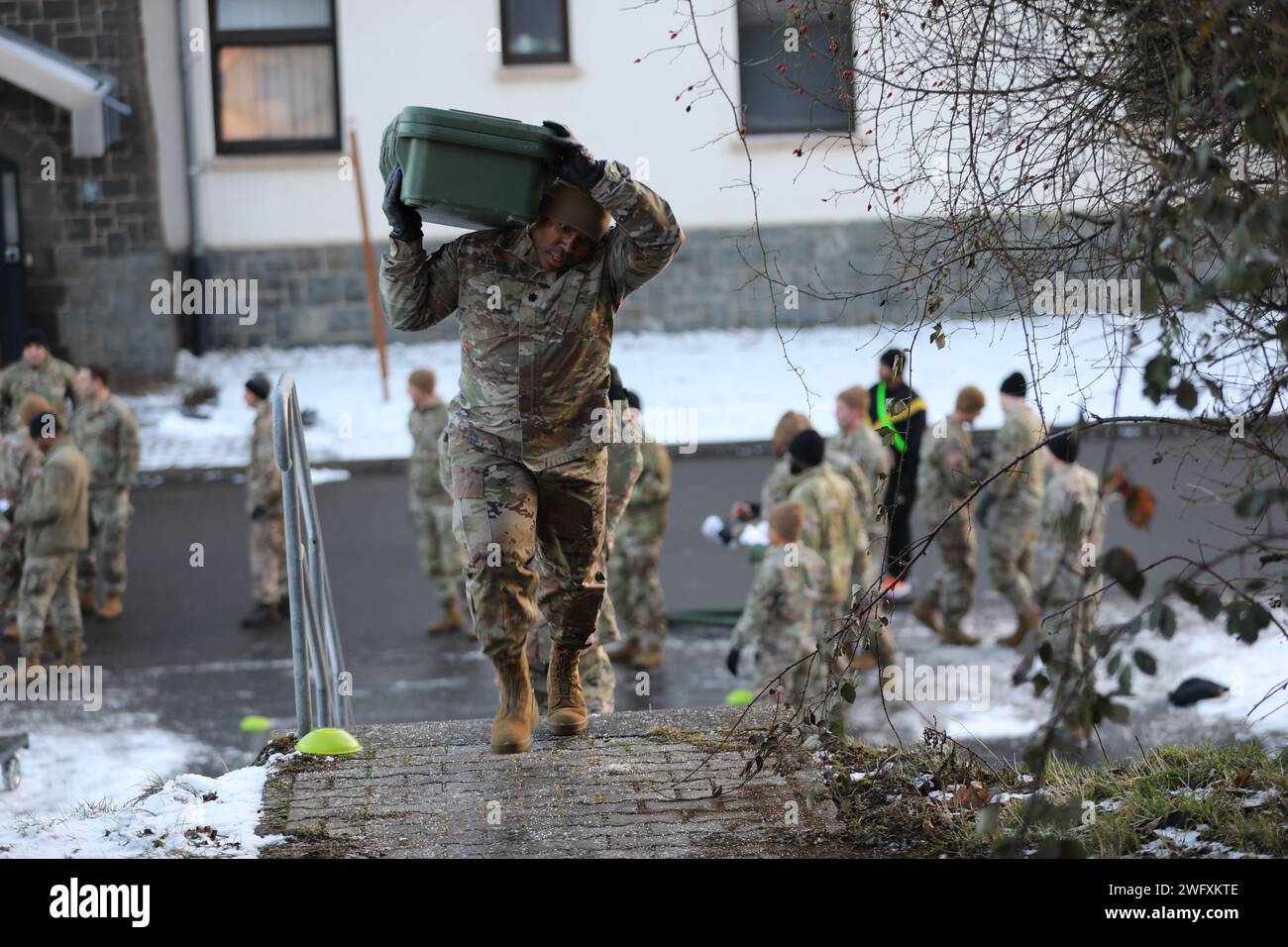 U.S. Army Lt. Colonel Tony Taylor, carries an insolated food container ...