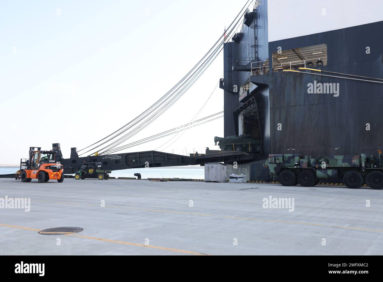 A U.S. Army Stryker vehicle is driven and unloaded off a transportation ...