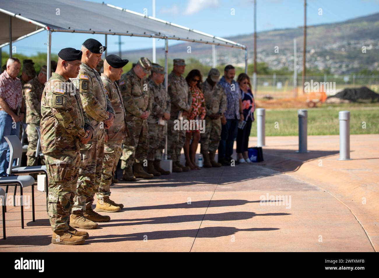 U.S. Soldiers, distinguished visitors and family members bow their ...