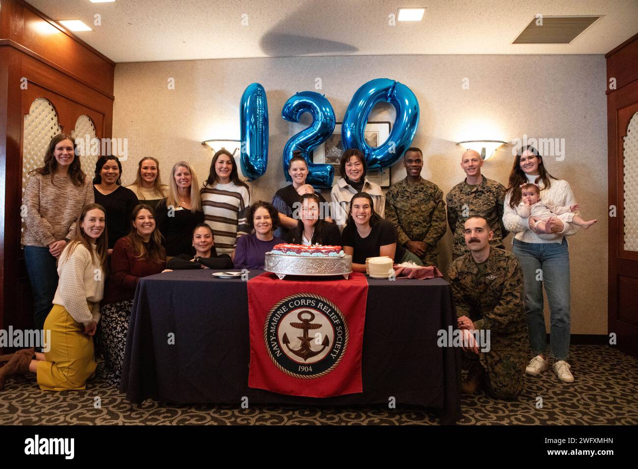 Volunteers with the Navy and Marine Corps Relief Society pose for a ...
