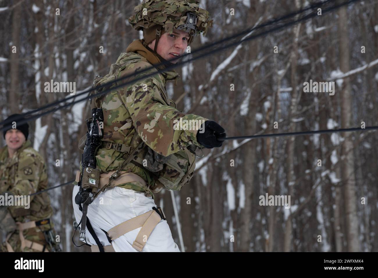 A squad member from the 1st Brigade Combat Team helps pull up teammates ...