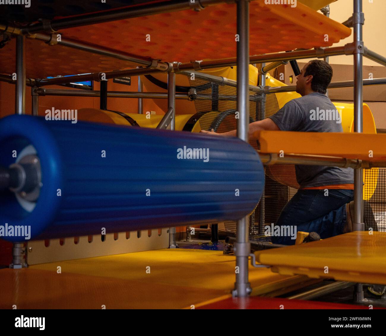 Travis Defusco, playground installation contractor, prepares to fit a ...