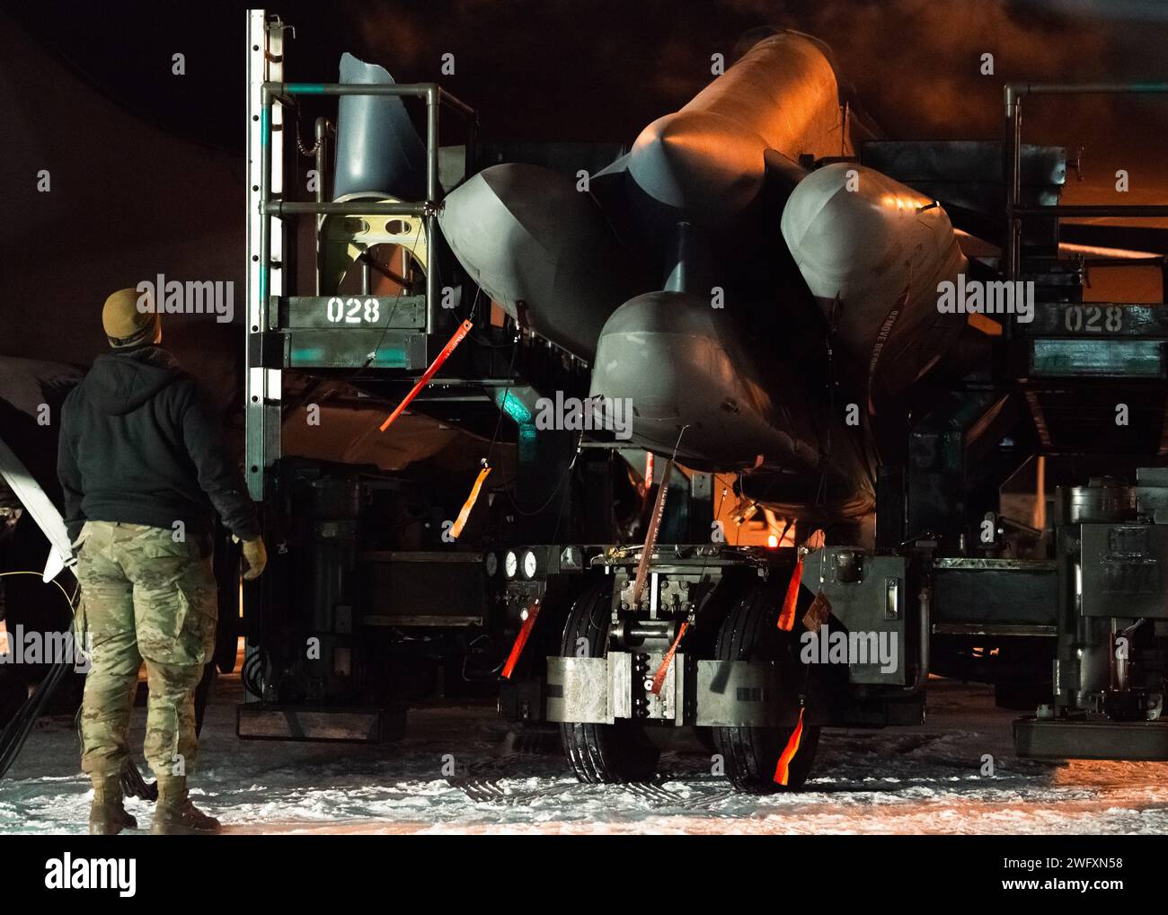 Airmen with the 5th Maintenance Group load AGM-86 air-launched cruise ...